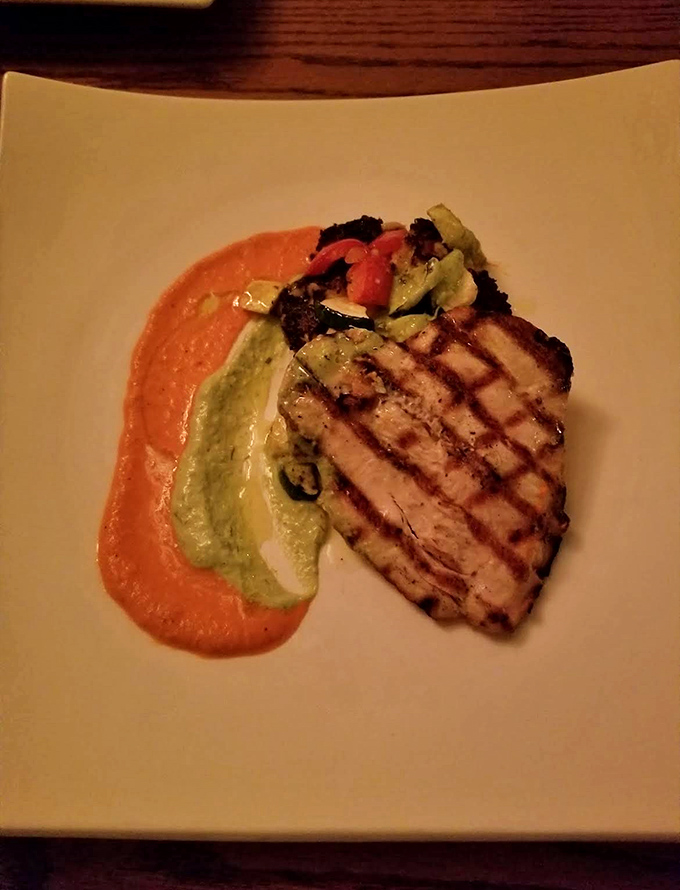 Grilled fish rests on vibrant sauces that look like an artist's palette &ndash; proof that eating with your eyes happens before the first bite.