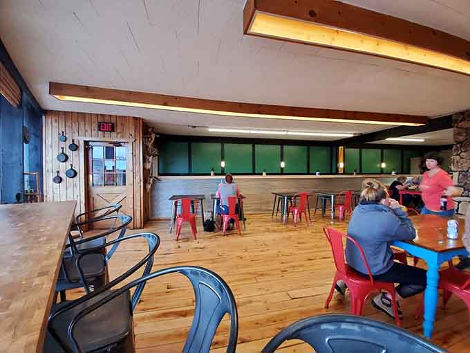 The dining area blends rustic charm with playful touches, where mismatched furniture somehow creates perfect harmony.