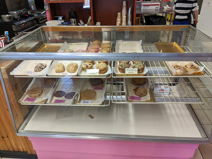 That bakery case filled with scones, cookies, and various treats is basically a museum of deliciousness you can actually eat.