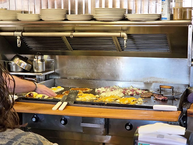 That griddle works overtime during the morning rush, covered with eggs, hash browns, and pancakes all cooking simultaneously in a carefully choreographed breakfast ballet.