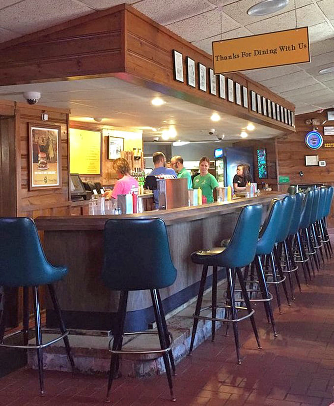 The bar area serves as community headquarters, where locals gather and cold beverages flow alongside great conversation always.