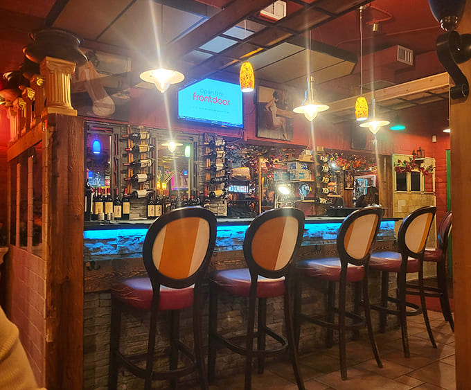 Another angle reveals the thoughtful lighting and comfortable seating that makes this bar perfect for solo dining or catching up with friends over drinks.