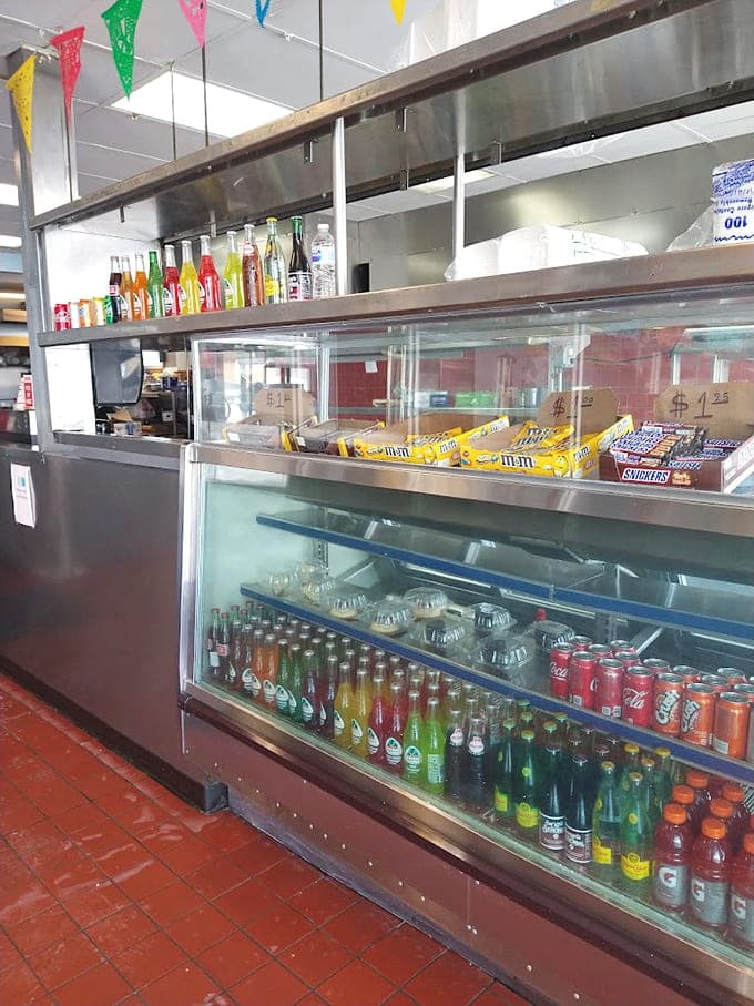The display case holds treasures and treats, from candy bars to cold drinks, ready to complete your meal or fuel your journey.