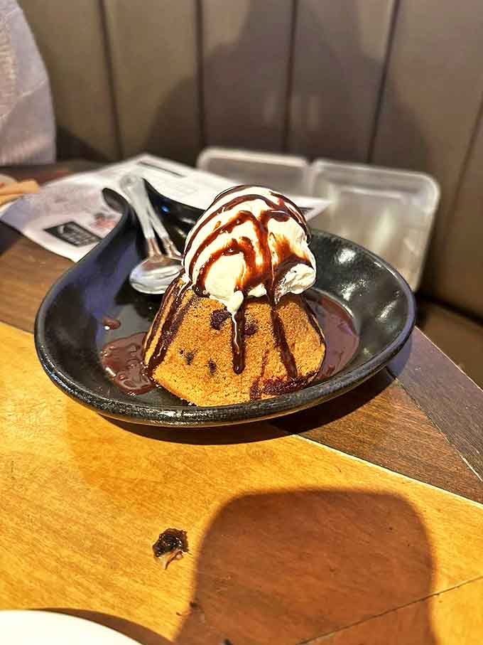 The molten lava cookie collapses under its own deliciousness, ice cream melting into warm chocolate like automotive dreams into reality.