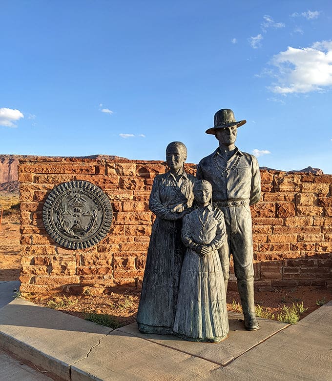 This statue honors the Navajo families who've called this sacred valley home for generations, their legacy as enduring as the rocks.