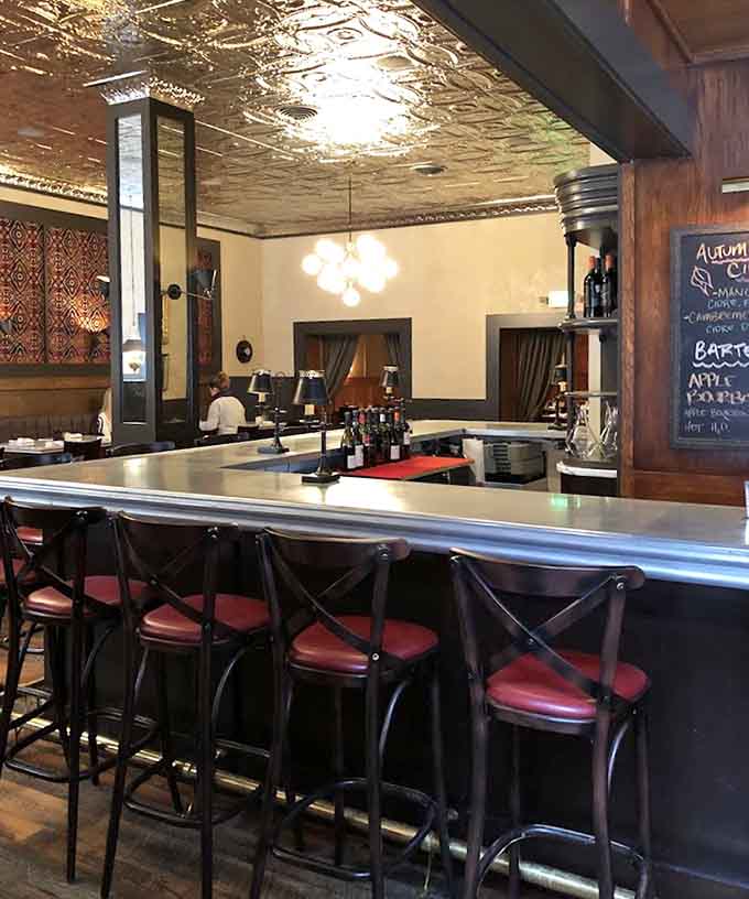 The bar beckons with promise, offering everything from morning coffee to evening cocktails crafted with actual skill and care.