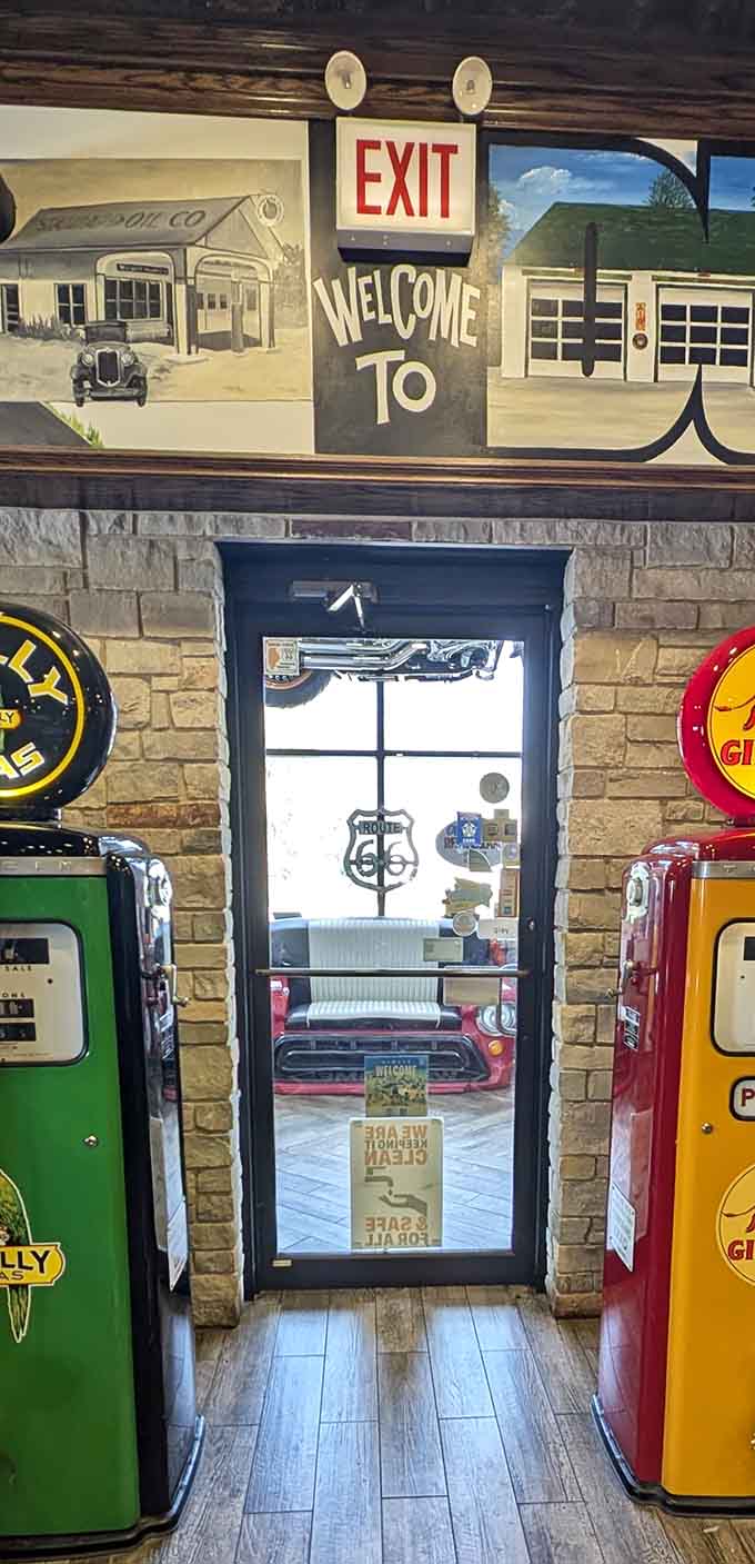 Vintage gas pumps flanking the doorway transport you back to when road trips meant adventure and every stop told a story.