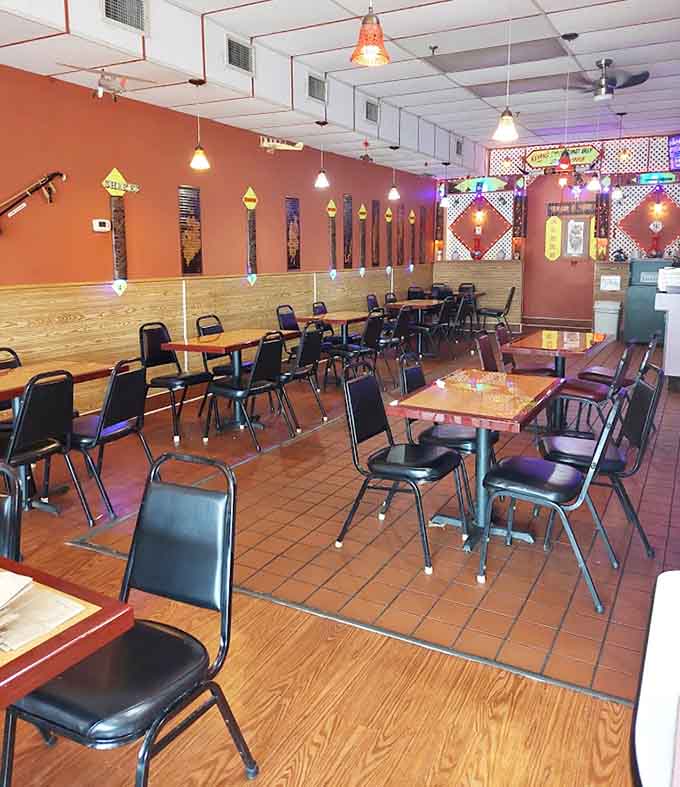 Spacious dining room with wood-paneled walls and cheerful yellow signage, offering plenty of room to enjoy your meal.