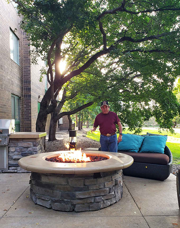 A cozy fire pit area offers a gathering spot for evening relaxation&mdash;the perfect place to unwind after a day of playground adventures.