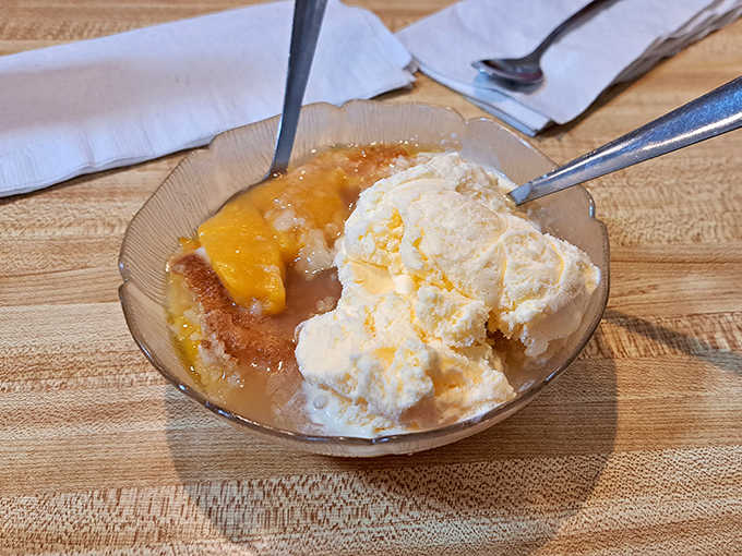 Warm peach cobbler meets cold vanilla ice cream in a dessert romance that's been making diners swoon for generations.