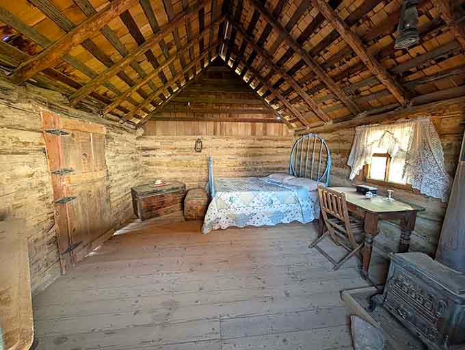 This sparse bedroom with its simple furnishings illustrates the modest living conditions that pioneers accepted as normal, comfort being a relative concept.