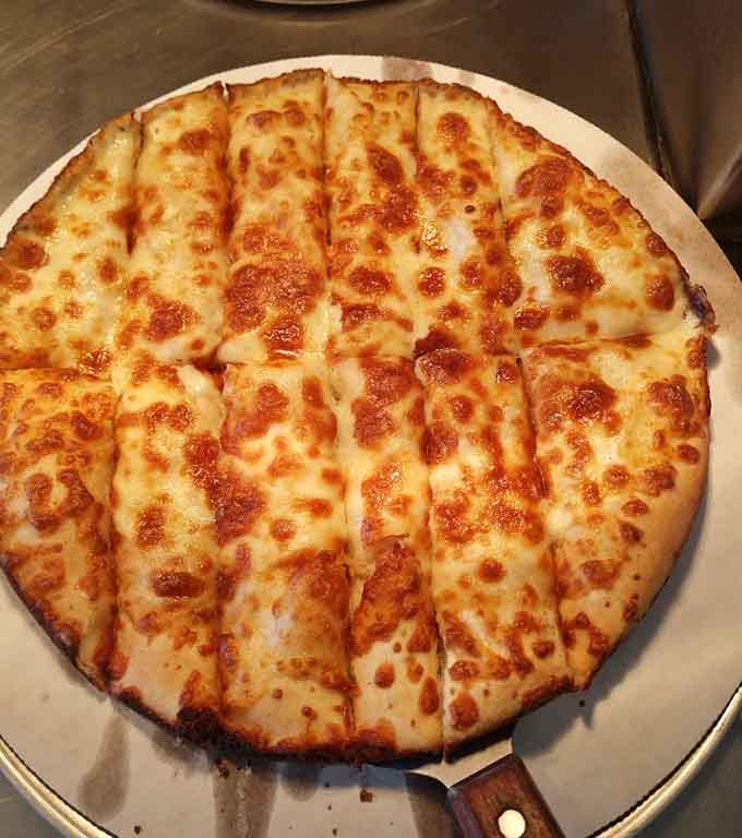 Pure cheese pizza perfection with that gorgeous golden-brown finish, like a blank canvas for your taste buds to appreciate.