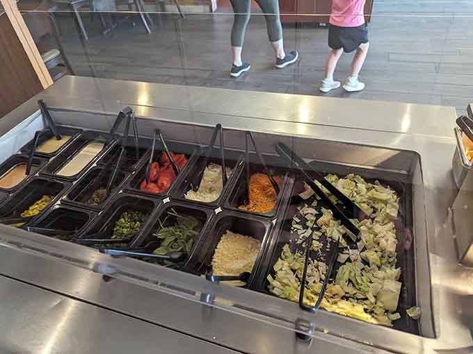 A well-stocked salad bar offers fresh vegetables for those brief moments when you pretend you're making healthy choices before more pizza.