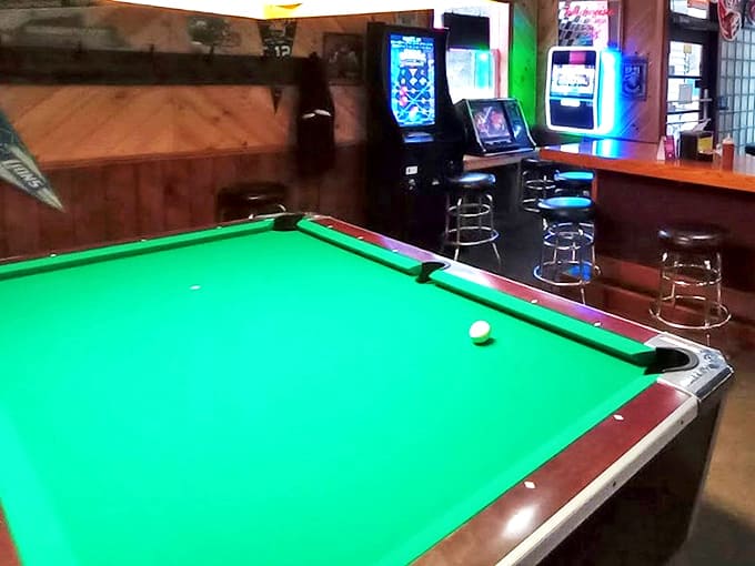 The pool table stands ready for friendly competition, its green felt surface having witnessed countless games and "I almost had you" moments.