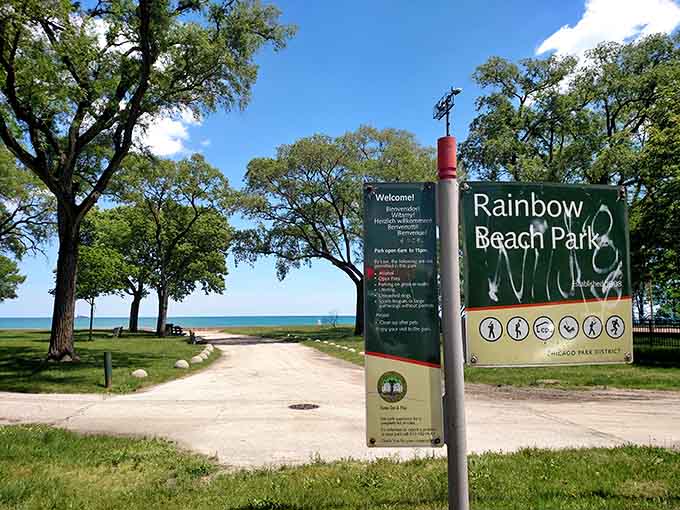 The welcome sign at Rainbow Beach Park stands ready to greet visitors, though the view behind it does most of the welcoming honestly.