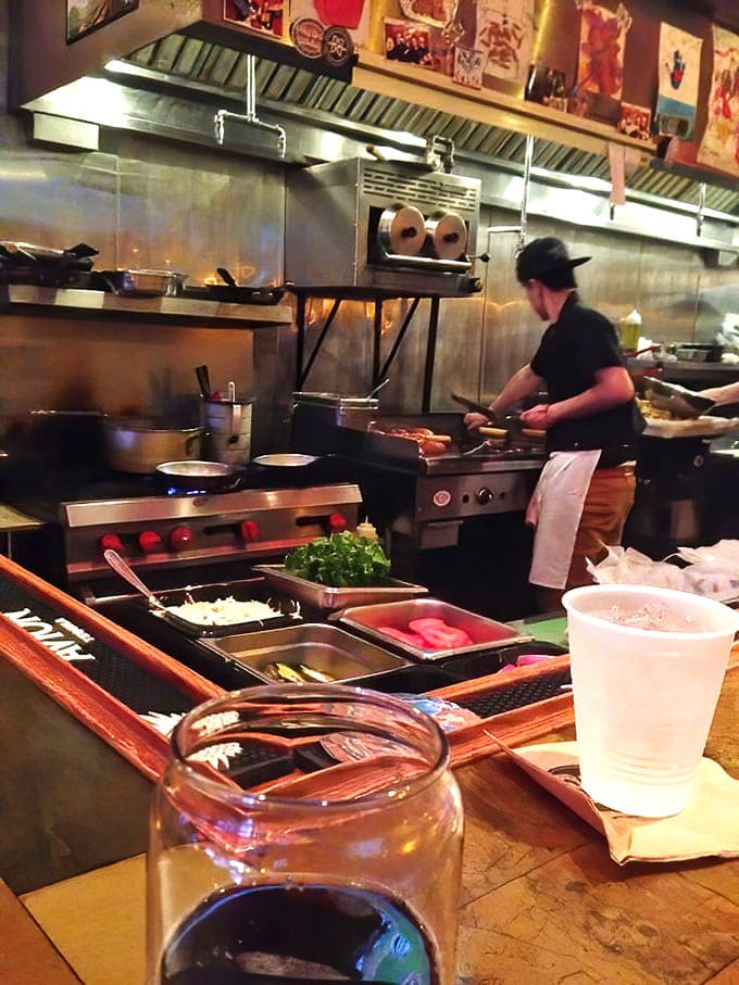 The open kitchen lets you watch the magic happen, with skilled cooks turning out dish after dish with the efficiency of a well-oiled machine.