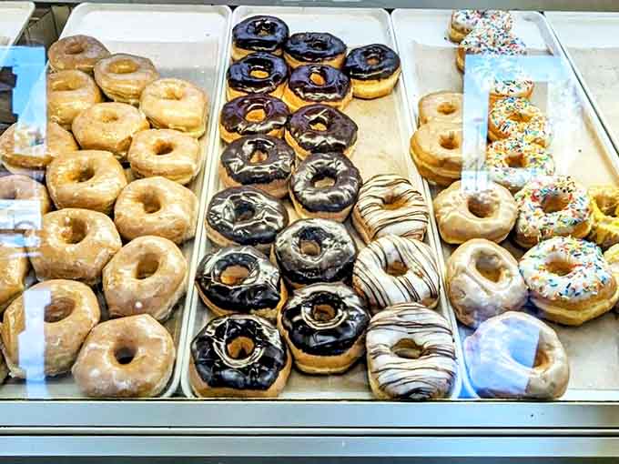 Donuts lined up like delicious soldiers &ndash; glazed, chocolate-covered, and sprinkled varieties all reporting for taste bud duty.