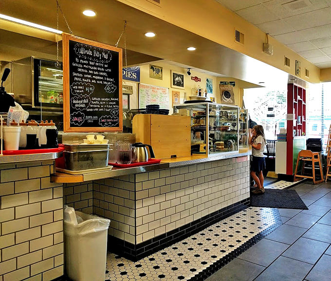 The service counter's classic white subway tiles and display case of temptations create that perfect diner aesthetic that says "we've been doing this right for years."