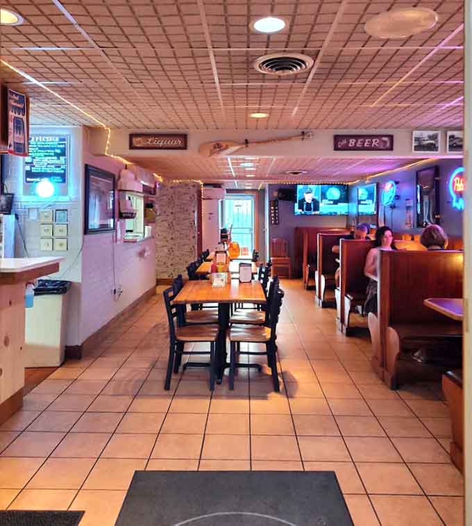 Another angle reveals the full scope of this welcoming space, complete with neon signs and screens for game day.