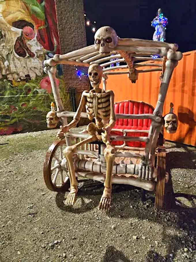 Have a seat, invites this skeletal figure from his macabre throne, perfect for visitors who need a bone-chilling photo opportunity.