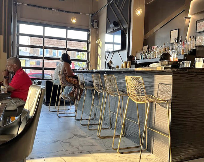The bar area where golden stools invite you to sit, sip, and contemplate your excellent life choices.