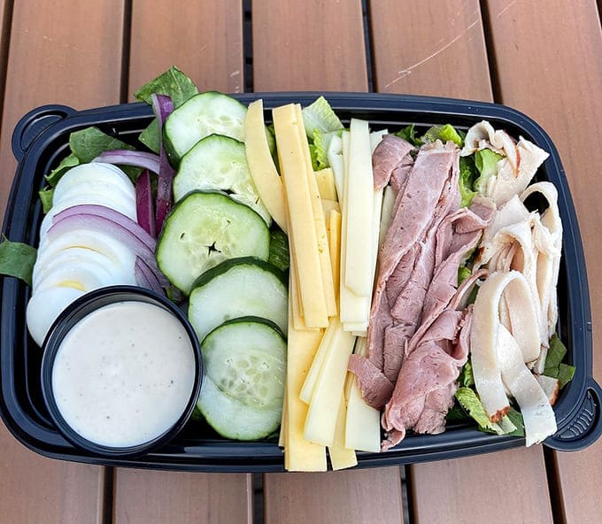 That salad looks suspiciously healthy for mountain food, but when you're eating with this view, even vegetables taste like victory.