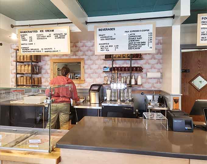 Behind the counter, the preparation area gleams with professional equipment and the promise of perfectly crafted treats to come.