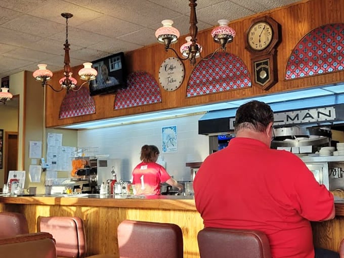 That classic diner counter with vintage lighting overhead is where solo diners become friends and coffee flows like a caffeinated river.