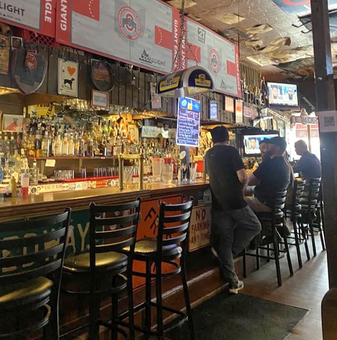 The bar gleams with possibilities, bottles lined up like soldiers ready to complement whatever massive sandwich you've just ordered.