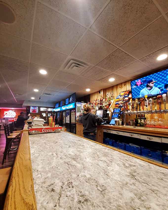 The bar area showcases an impressive tap selection, perfect for washing down whatever burger masterpiece you've just devoured.