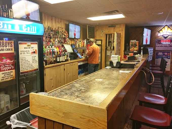 The well-stocked bar with its impressive selection invites guests to settle in for an evening of good drinks and conversation.