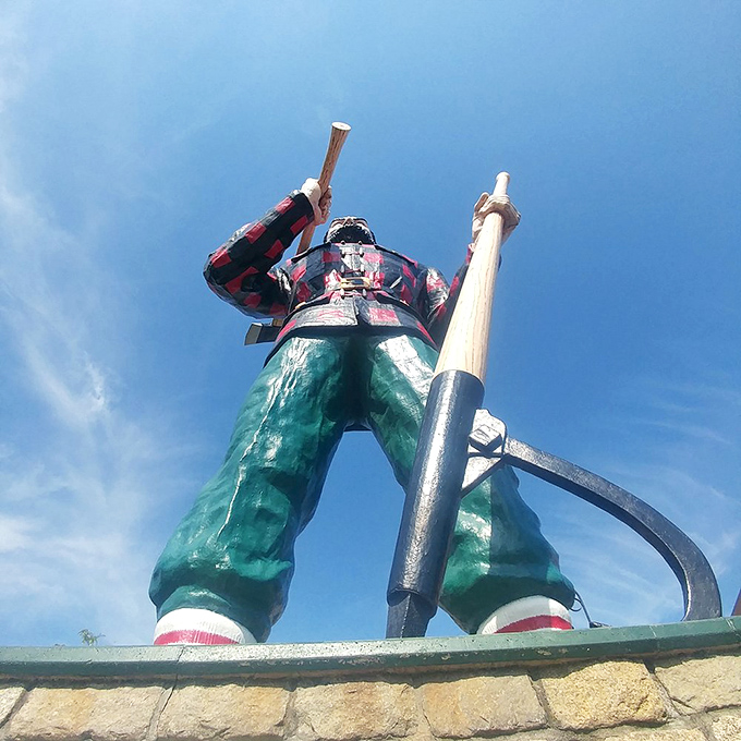 Sunlight plays across the statue's massive frame, highlighting the craftsmanship that's kept this fiberglass giant standing tall through decades of harsh Maine weather.