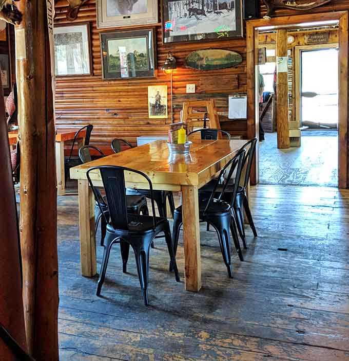 Wooden tables and wildlife art create a dining room that feels authentically Northwoods, not theme-park fake.