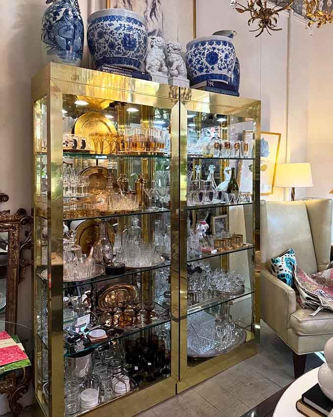 Crystal glassware and blue ceramics sparkle behind glass like jewelry for your dining room, because apparently even your dishes deserve to make a statement.