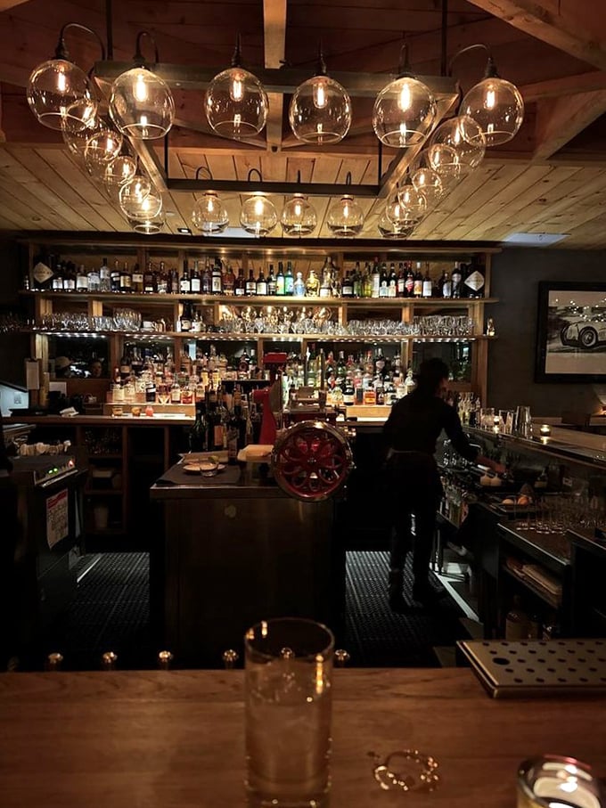 The bar glows with amber light and endless possibilities – where craft cocktails and local conversation flow with equal enthusiasm.
