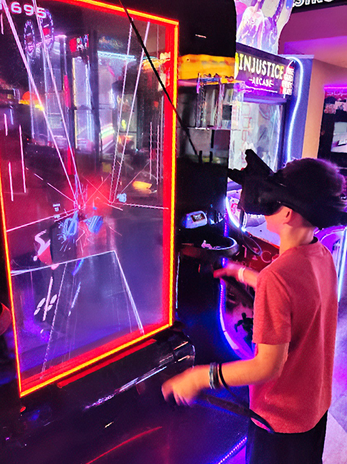 Reality is overrated! This young gamer is slicing through the virtual world like a Jedi in training. May the force of fun be with him!