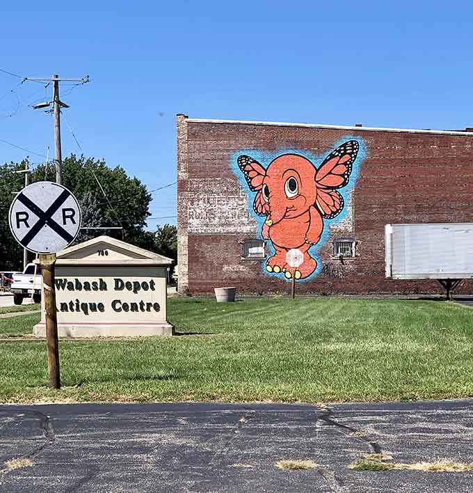That cheerful elephant mural suggests the whimsy waiting inside, because nothing says "antique store" quite like a butterfly-winged pachyderm welcoming visitors.
