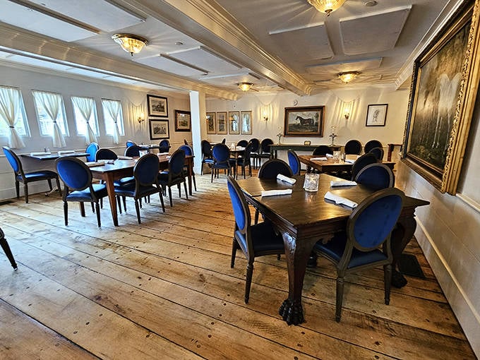 Elegant simplicity defines this dining space, where wide-plank floors and white walls create a canvas for memorable meals.