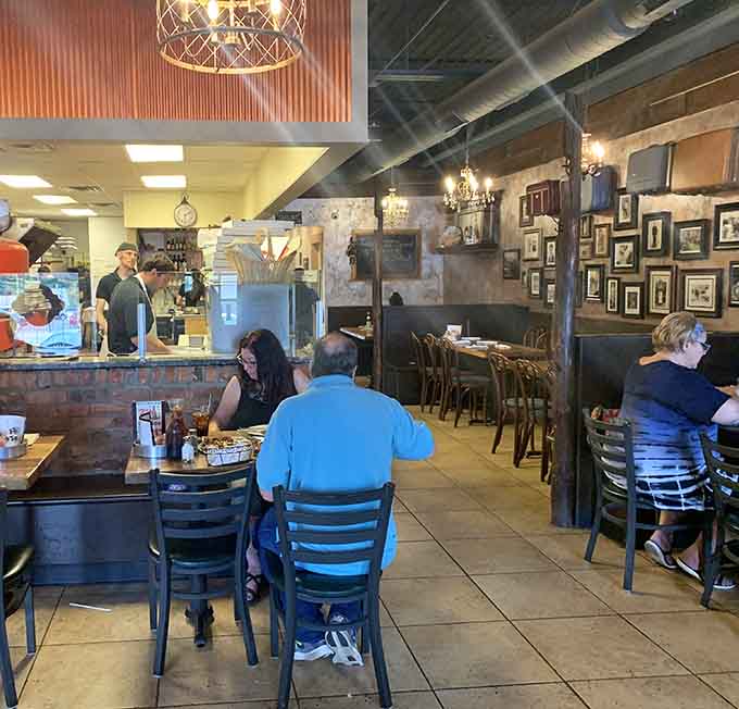 Real people enjoying real pizza in a real restaurant, no staged photos needed when the food speaks this loudly.