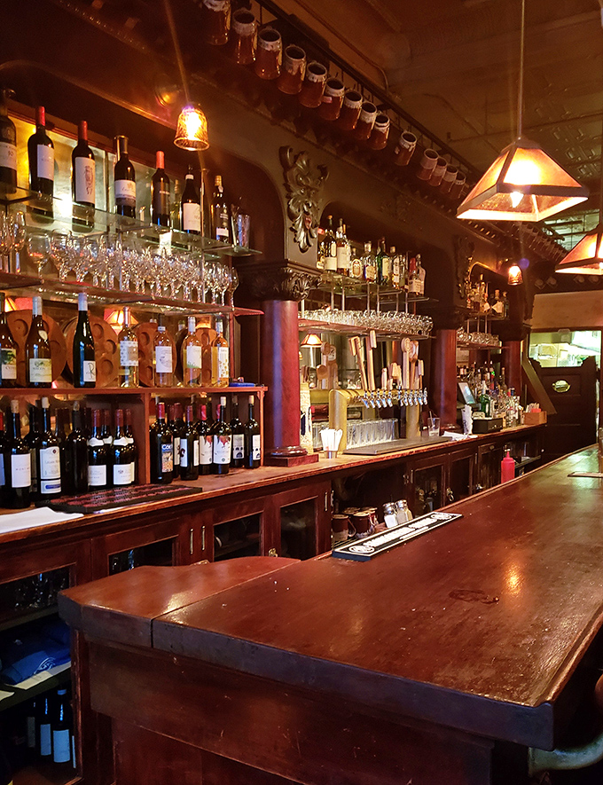 The bar gleams with promise under warm lighting, bottles standing at attention like soldiers ready to enhance your dining experience.