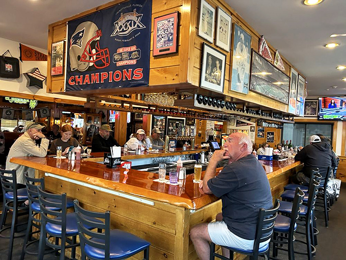 The bar area buzzes with locals and visitors, Patriots memorabilia overhead confirming you're in the heart of New England territory.