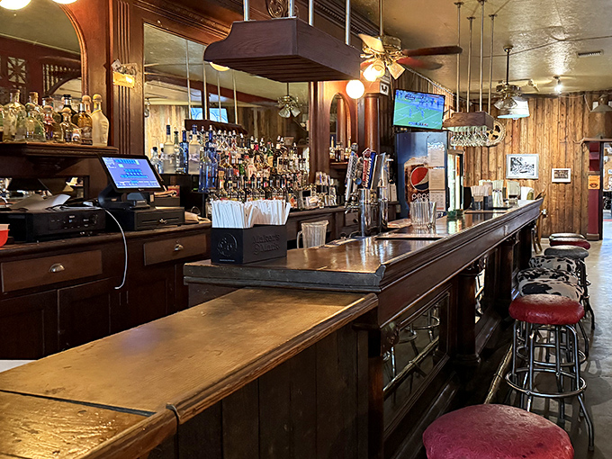 The bar area doesn't just serve drinks&mdash;it serves history, with each worn barstool holding the imprint of decades of travelers seeking respite from the desert road.