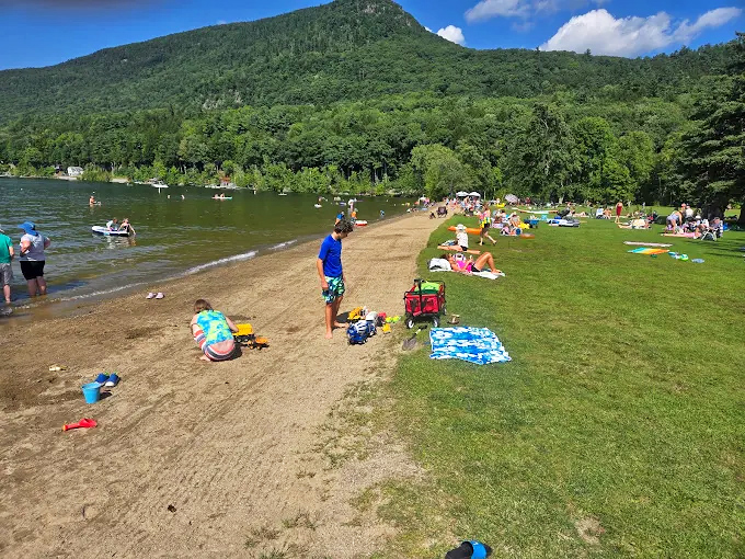 Beach-goers claim their spots along the sandy shore, each creating their own version of a perfect summer day.