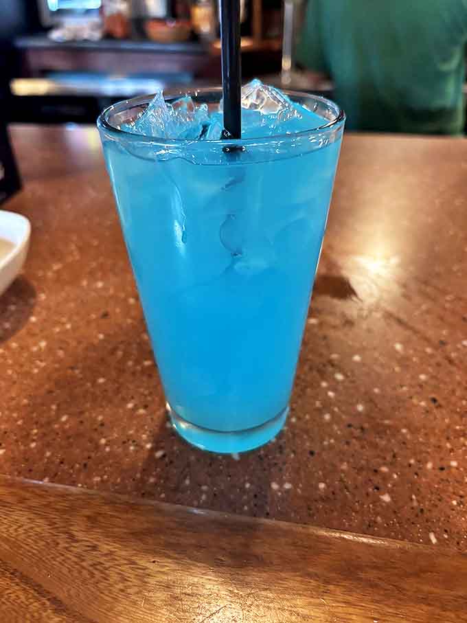 An electric blue cocktail catches the eye and promises refreshing flavors &ndash; a colorful counterpoint to traditional pub offerings.