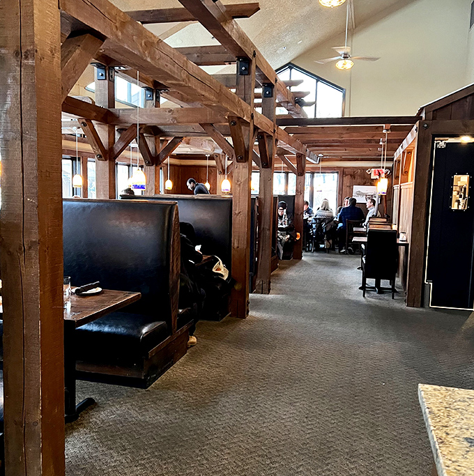 Timber-framed booths create semi-private dining nooks where conversations flow as easily as the Vermont craft beers on tap.