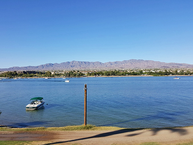 Boats dot the tranquil waters like toys in a giant's bathtub, surrounded by mountains that have witnessed millennia.