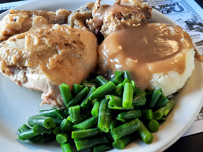 Tender chicken smothered in rich gravy alongside vibrant green beans &ndash; a plate that reminds you why these classics became classics.