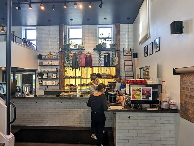 White subway tiles and wooden accents frame the stage where coffee and pastry perform their daily duet for appreciative audiences.