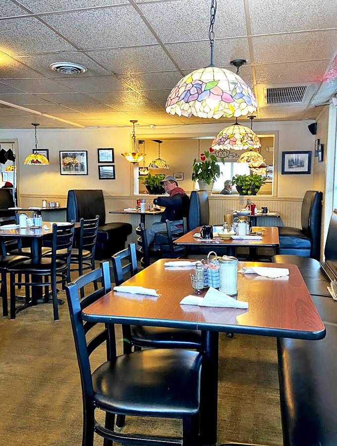 Tiffany lamps and lush greenery create an oasis of coziness. It's like dining in your coolest grandma's living room if she were a secret chef.