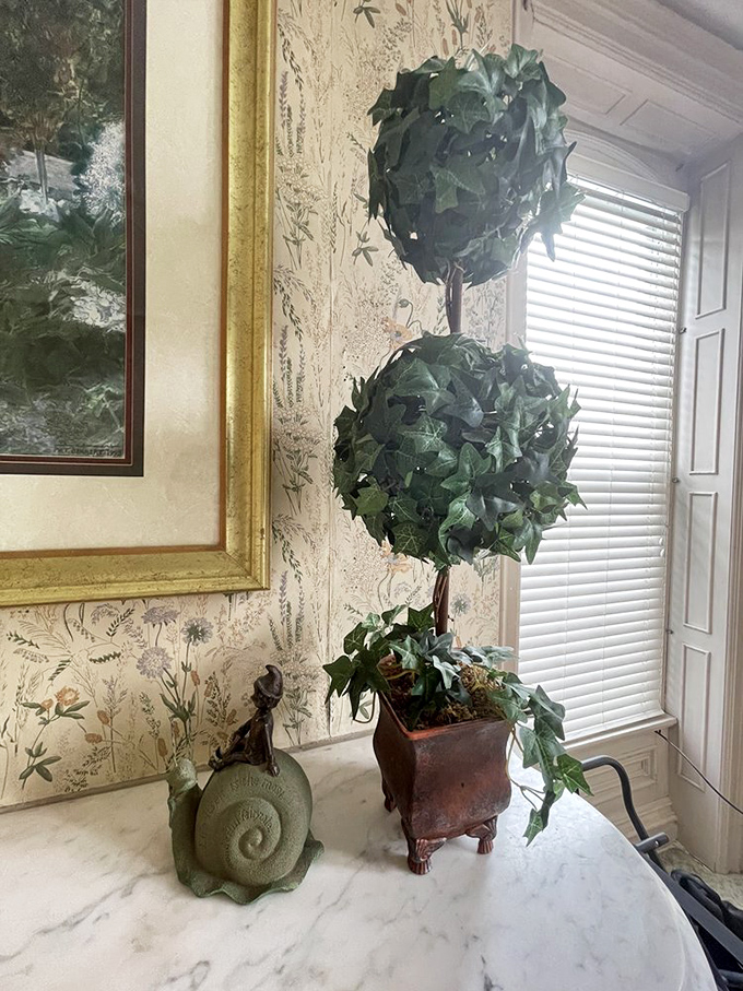 Decorative topiaries add touches of structured greenery, balancing the mansion's formal architecture with natural elements.